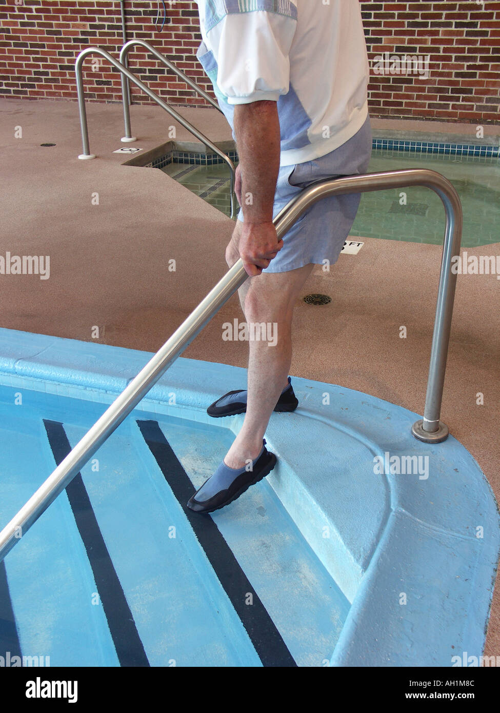 Stepping into Pool Stock Photo - Alamy
