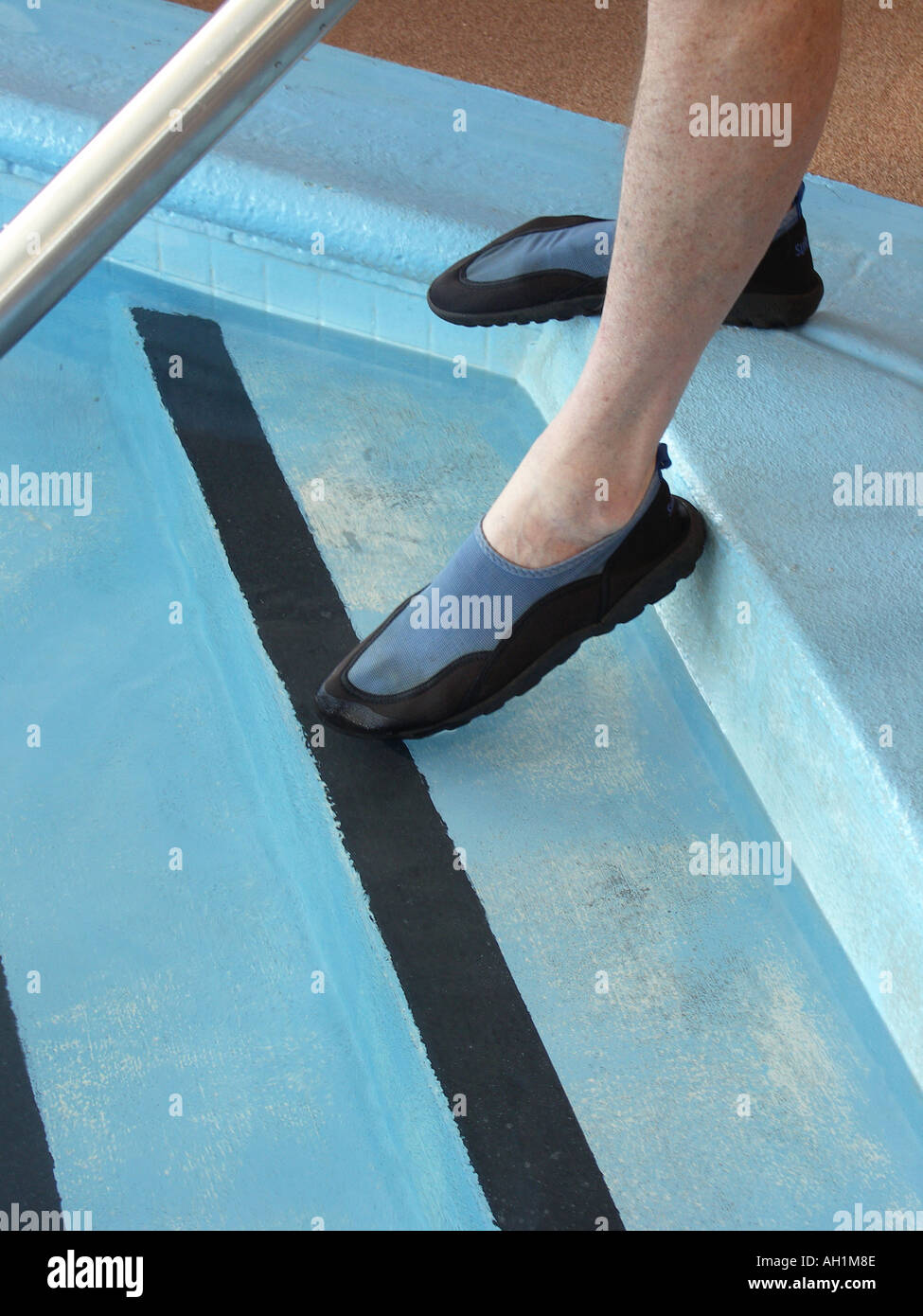 Stepping into Swimming Pool Stock Photo - Alamy