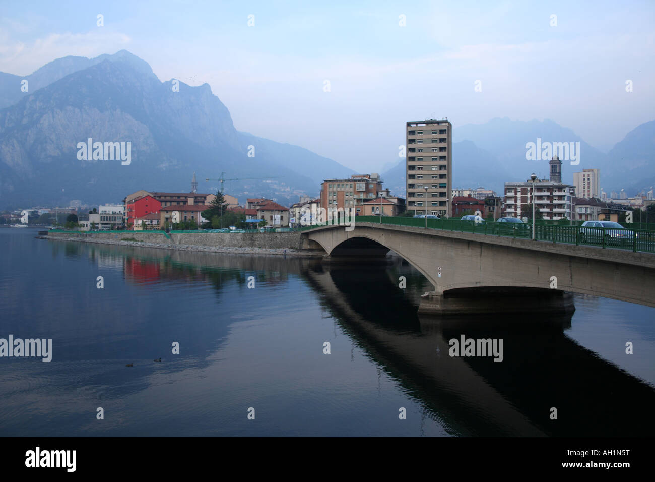Kennedy Bridge the town of Lecco and mountains reflected in Lake como ...
