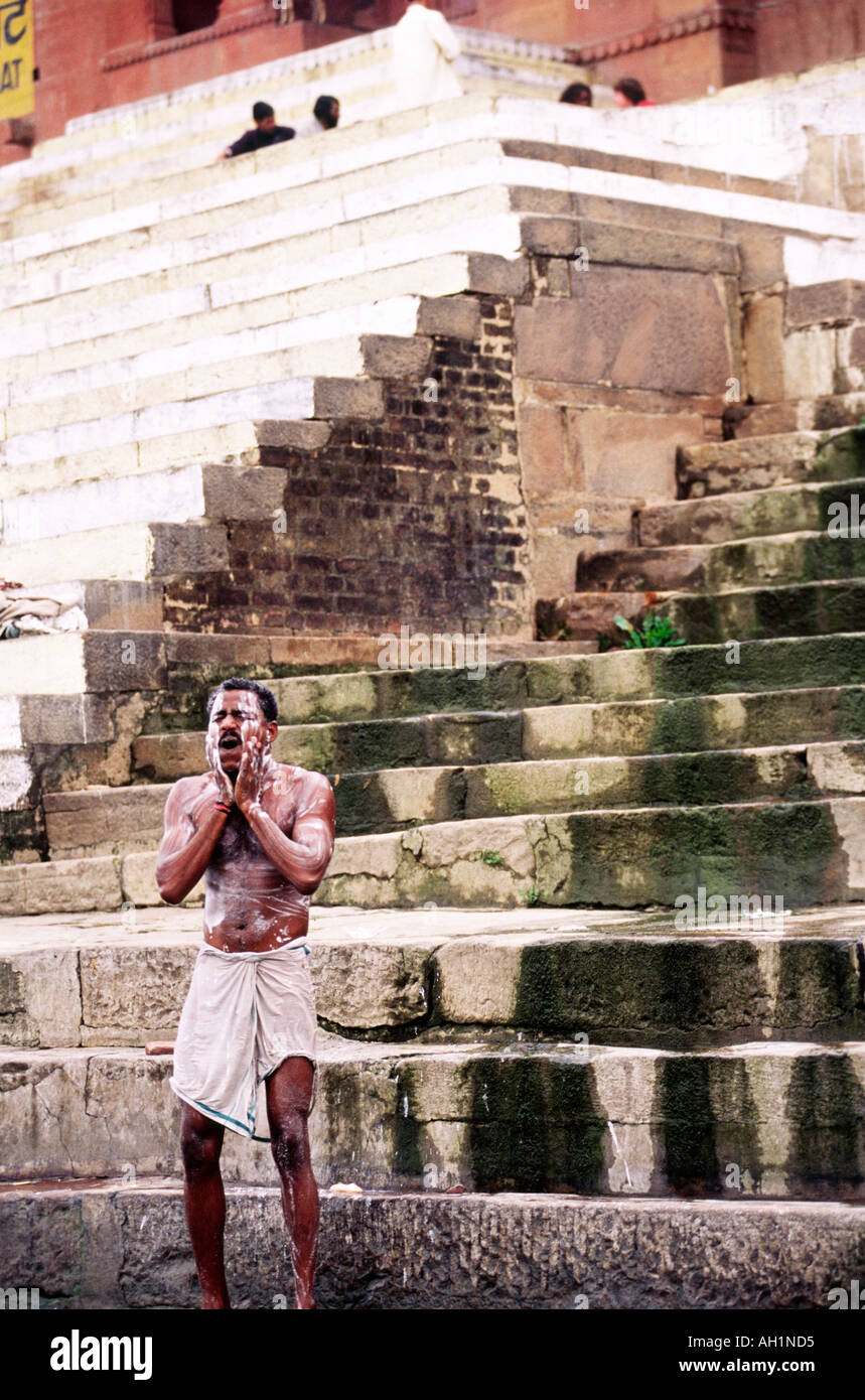 One male bathing and washing clothes on the edge of a Ghat steps on the ...