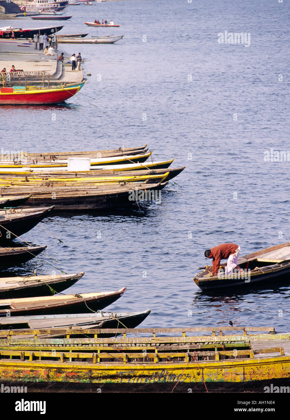 Long row or large wooden row boats on the edge of the river Ganges in ...