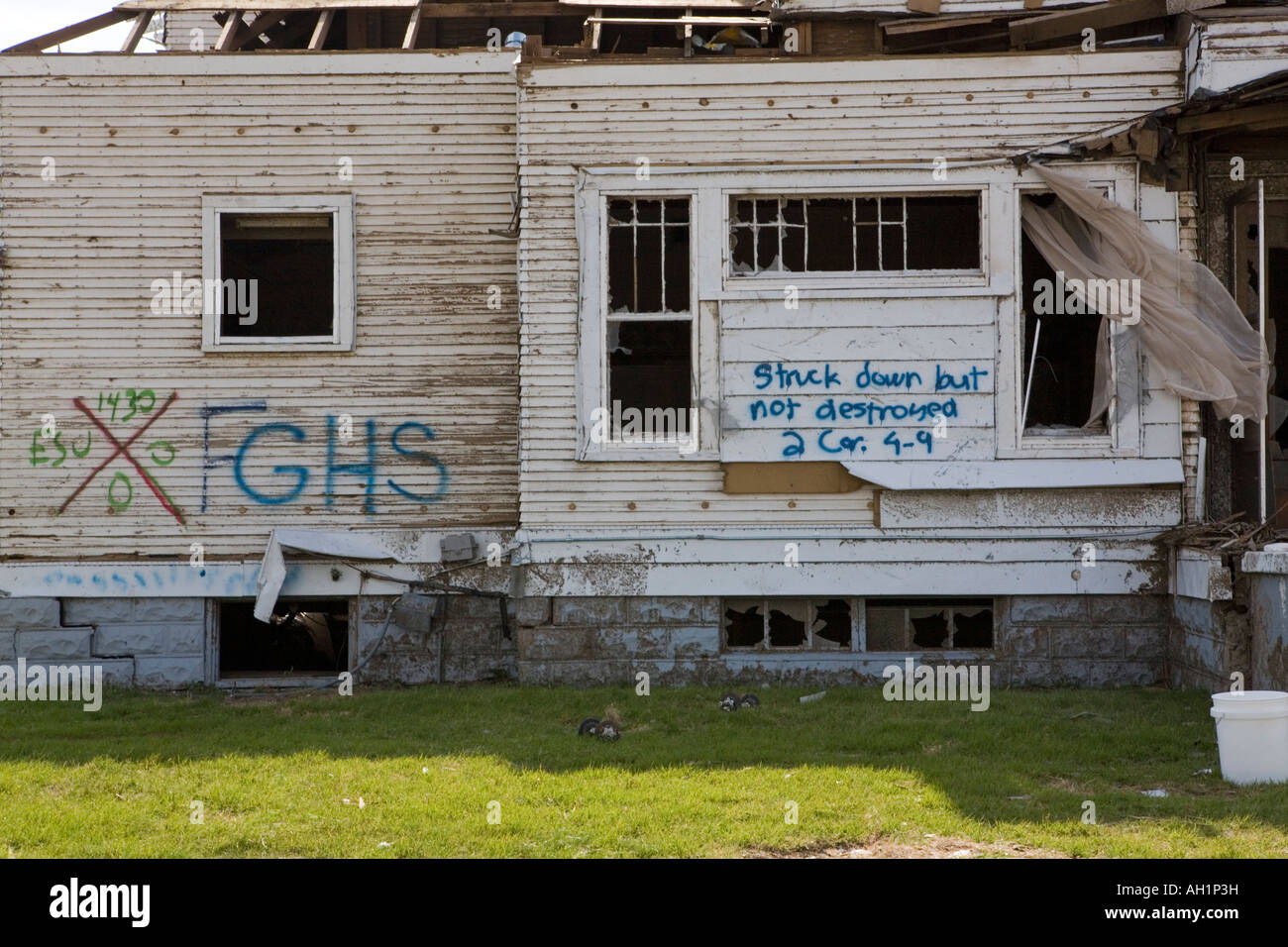 Tornado damaged house marked with emergency and religious markings in ...