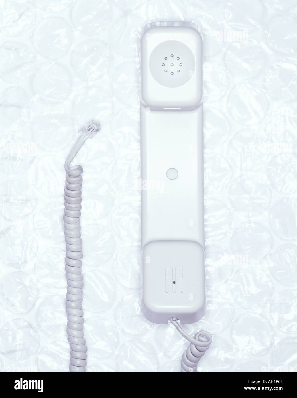 With business office telephone receiver on bubble textured surface with ...