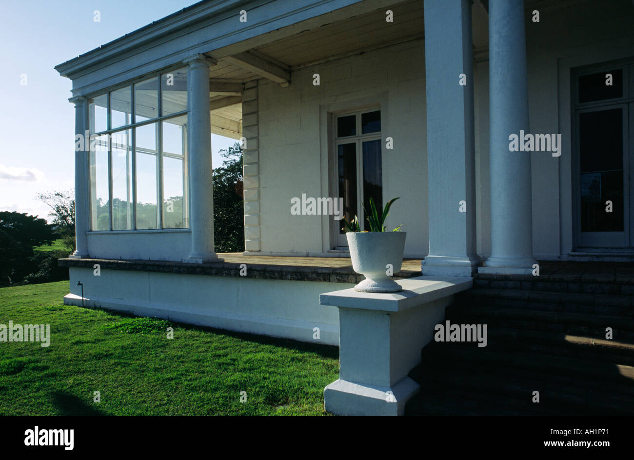Front veranda of a large wealthy house with statues by the side of a ...