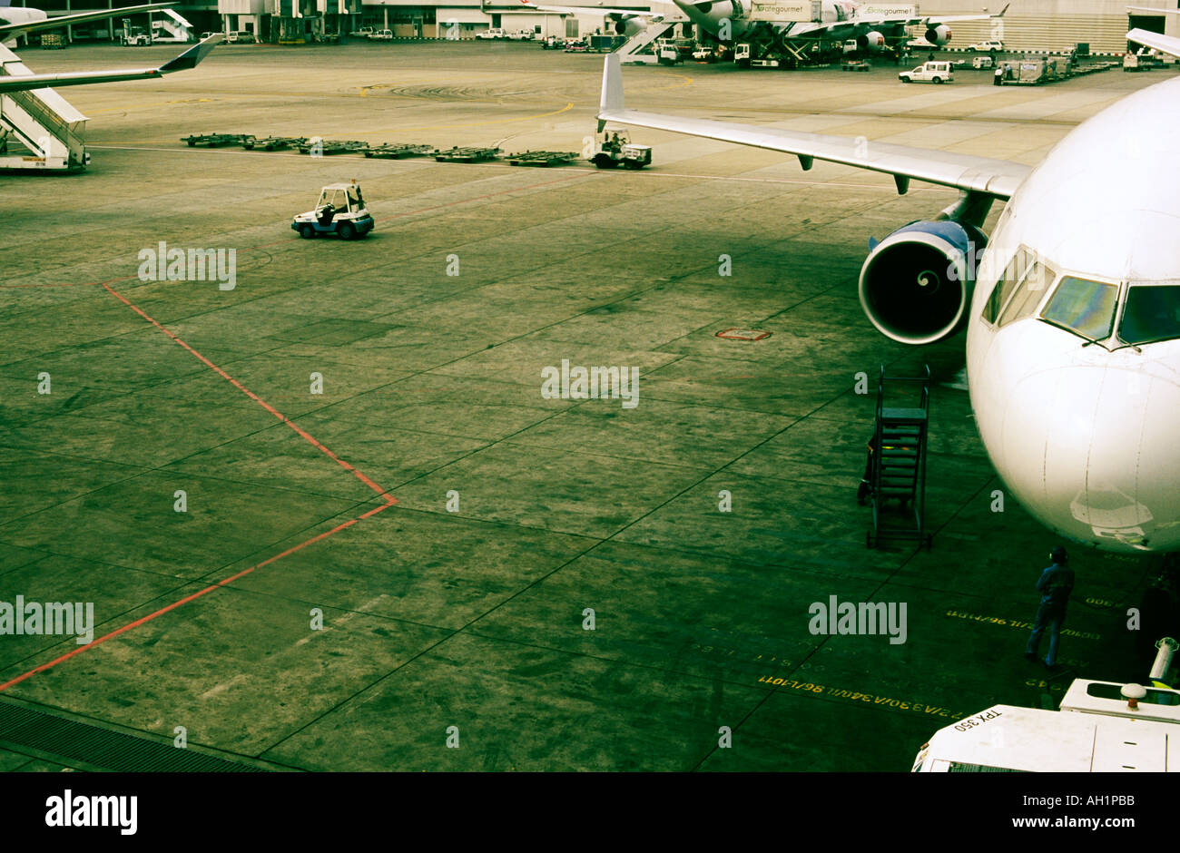 Busy international airport airplanes at the loading gates green blue ...