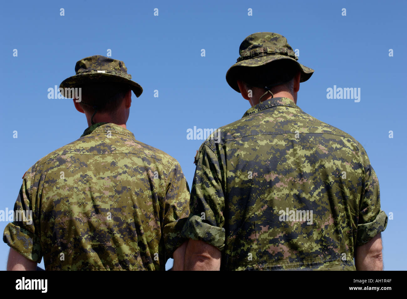 2 two Canadian army men in camouflage watching air show Stock Photo - Alamy