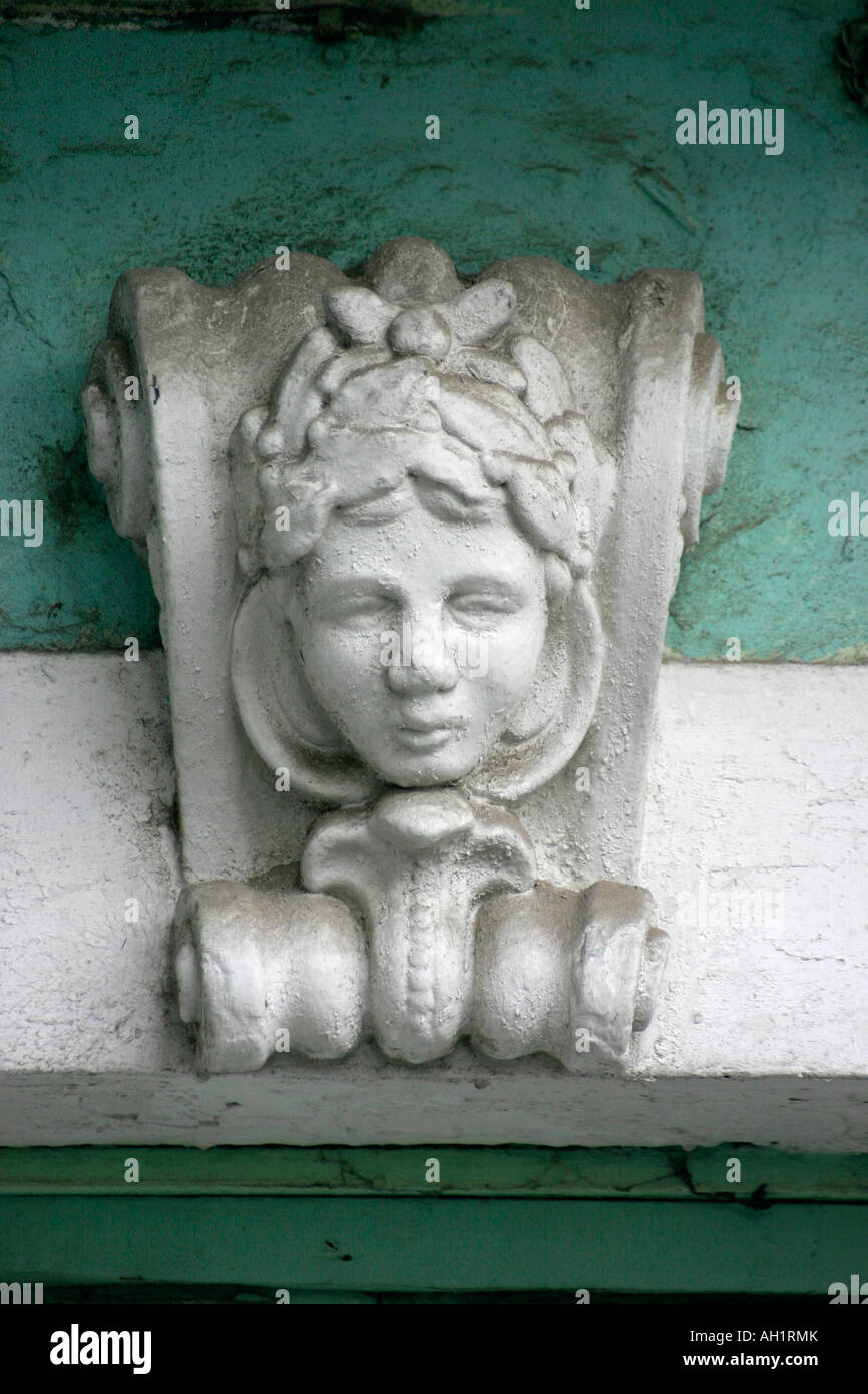 Decorative face on a wall at the entrance of a colonial building at el ...