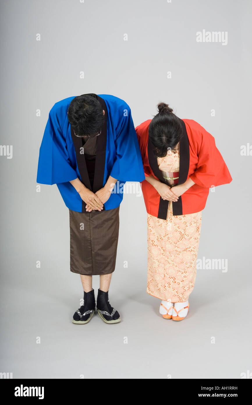 Man and woman bowing Stock Photo - Alamy
