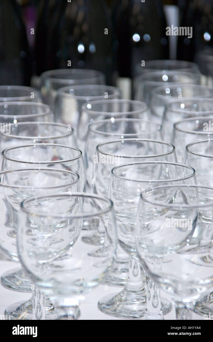 Wine bottles and glasses are setup for an event Stock Photo - Alamy