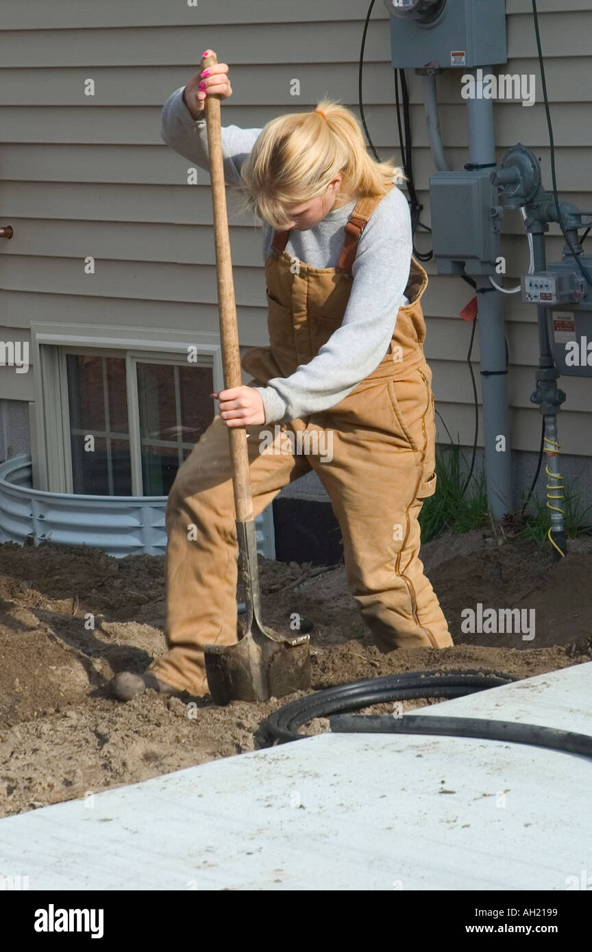 Female Installs Irrigation System in New Home construction Stock Photo ...