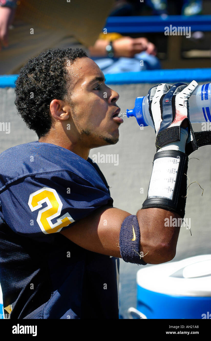 Football player Athlete Drinks Water to combat dehydration Stock Photo ...
