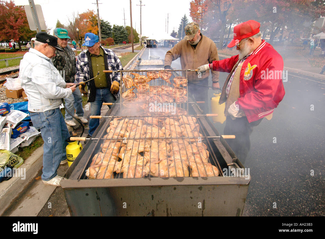 Men Grill Chicken at Festive Event in Cadillac Michigan Stock Photo - Alamy