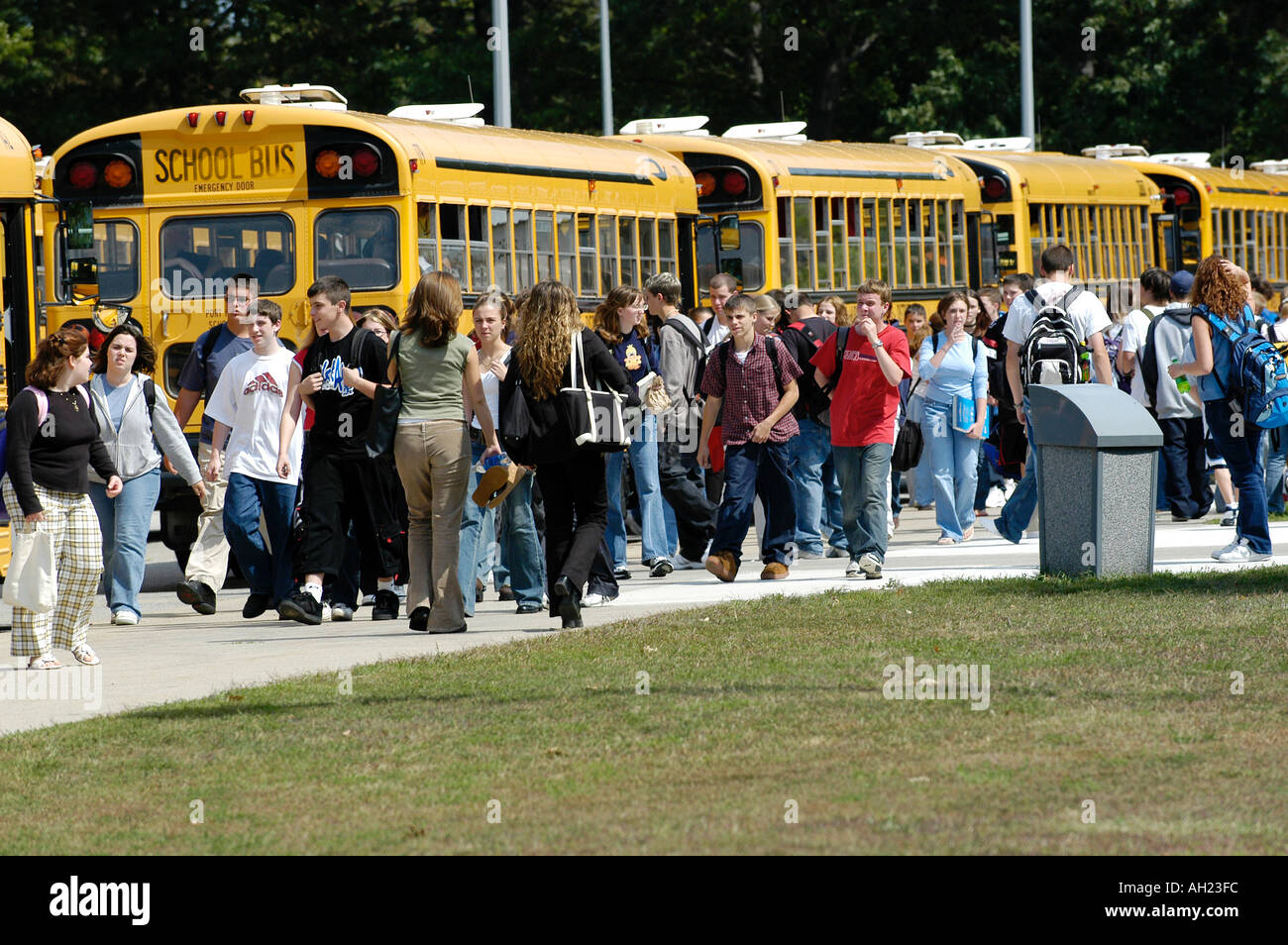 Students Board a School Bus to ride home after the end to the school ...