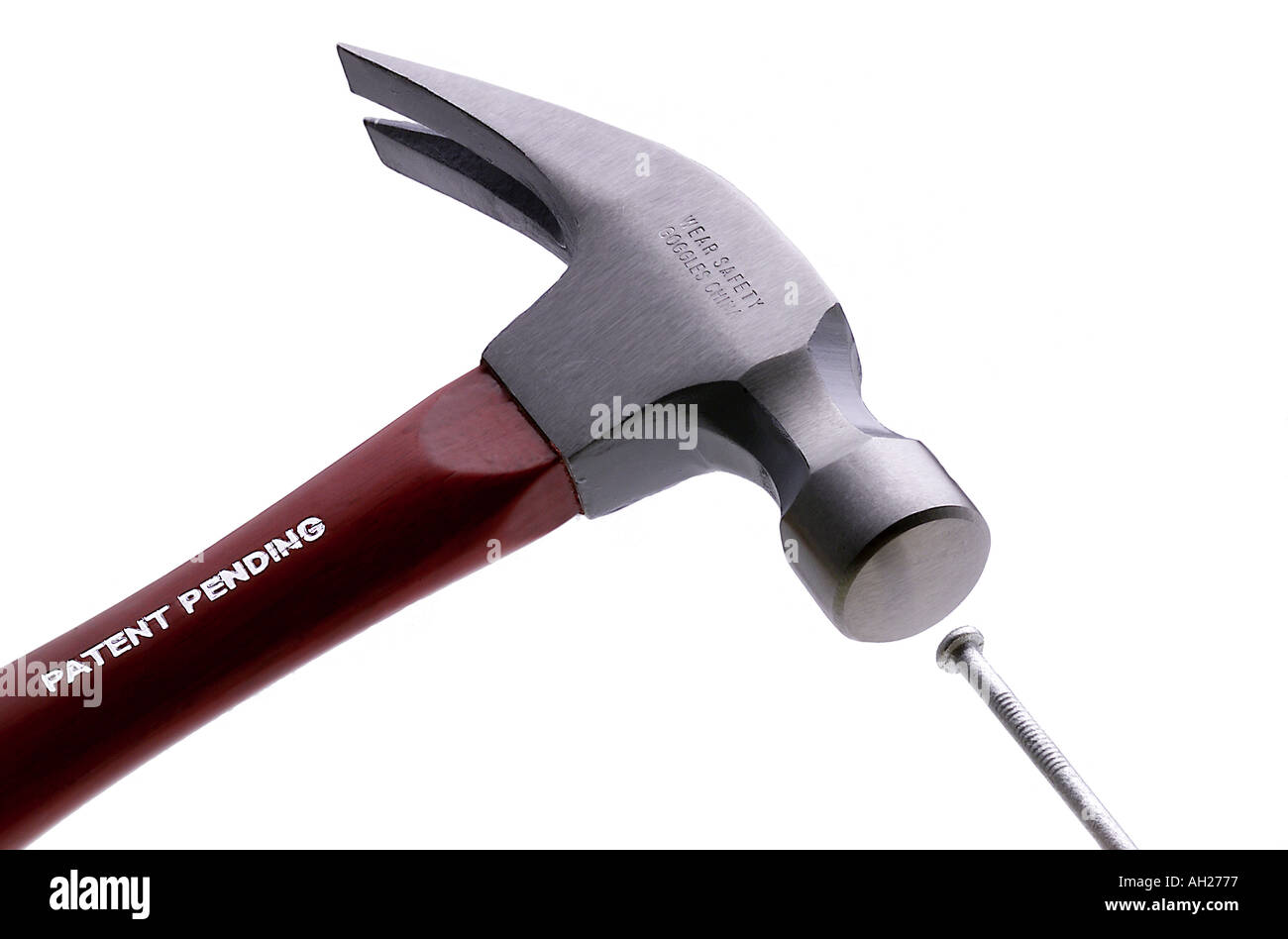 hammer striking a nail silhouetted on white background Stock Photo - Alamy