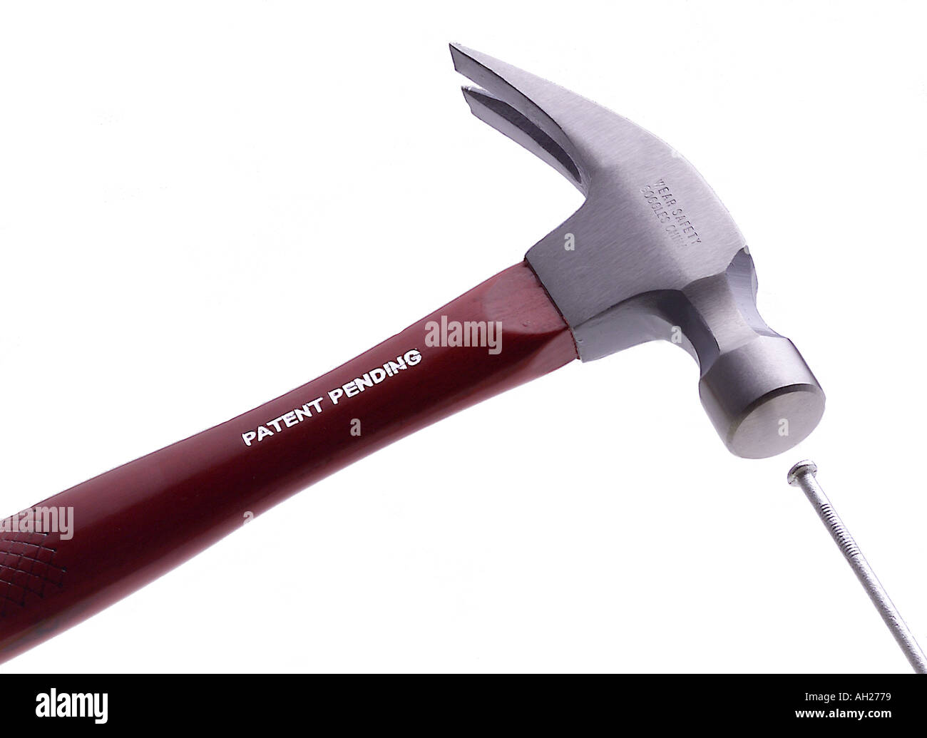 hammer striking a nail silhouetted on white background Stock Photo - Alamy