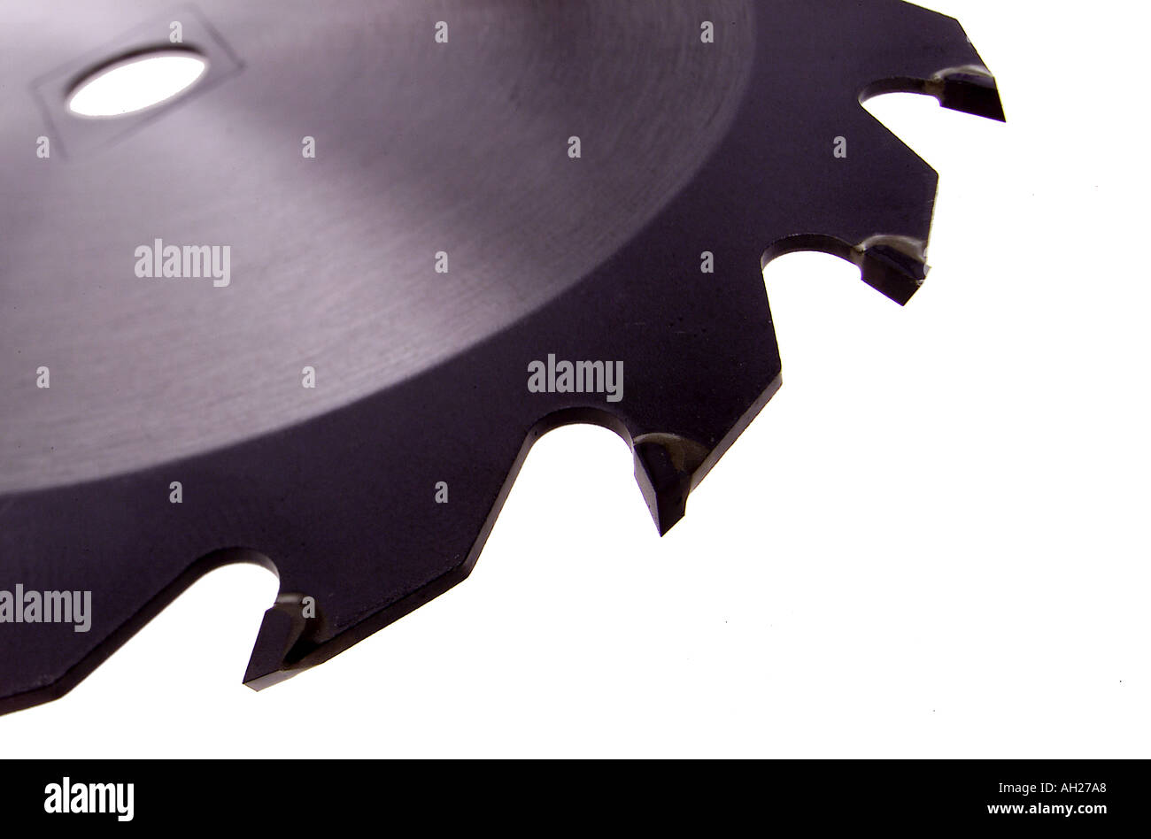 Close up rotary circular electrical saw blade silhouetted on white ...