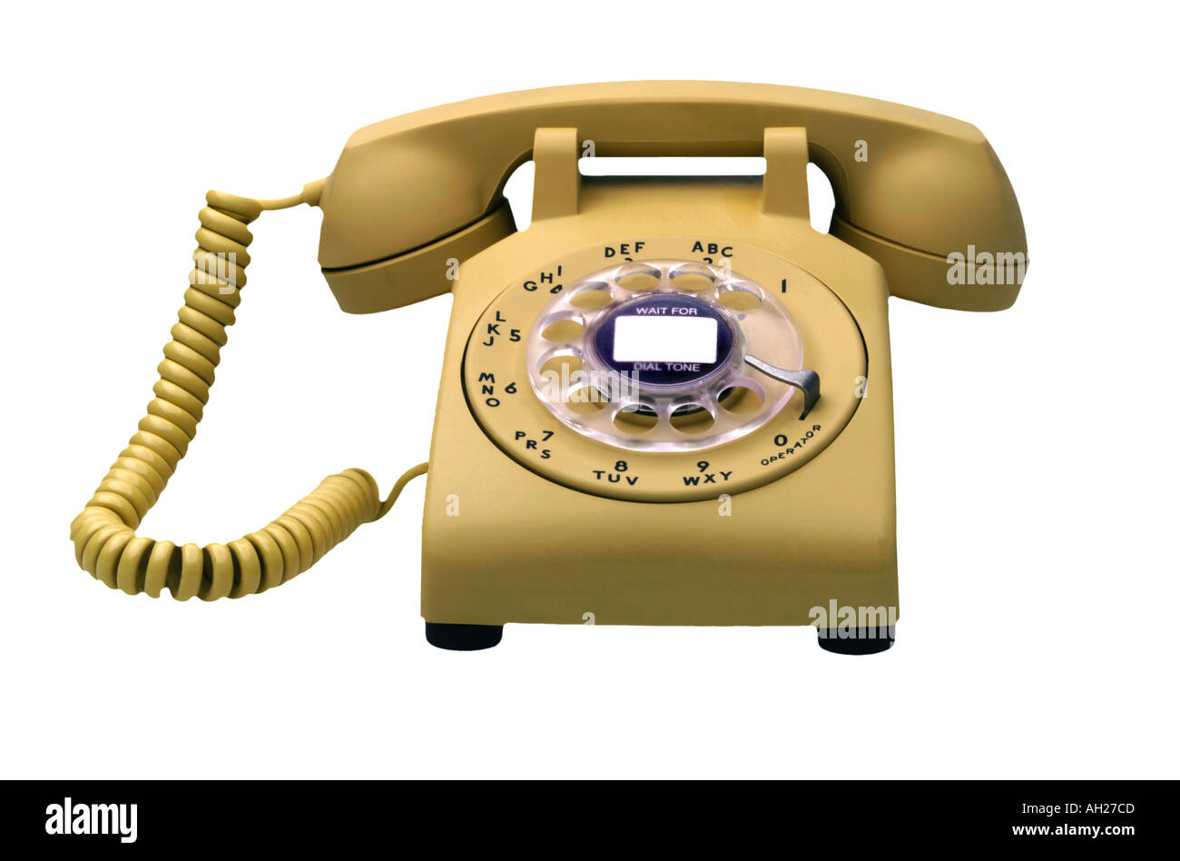 A retro, yellow rotary dial telephone silhouetted on white background ...