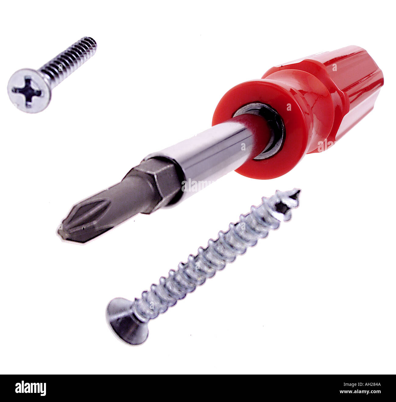 red handled phillips screwdriver with two screws silhouetted on white ...