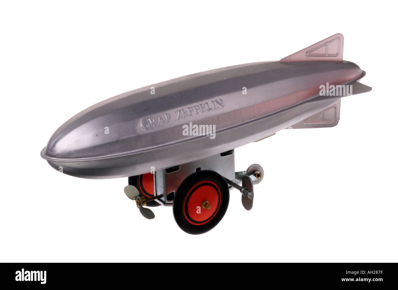 antique metal wind up toy zeplin silhouetted on white background Stock ...