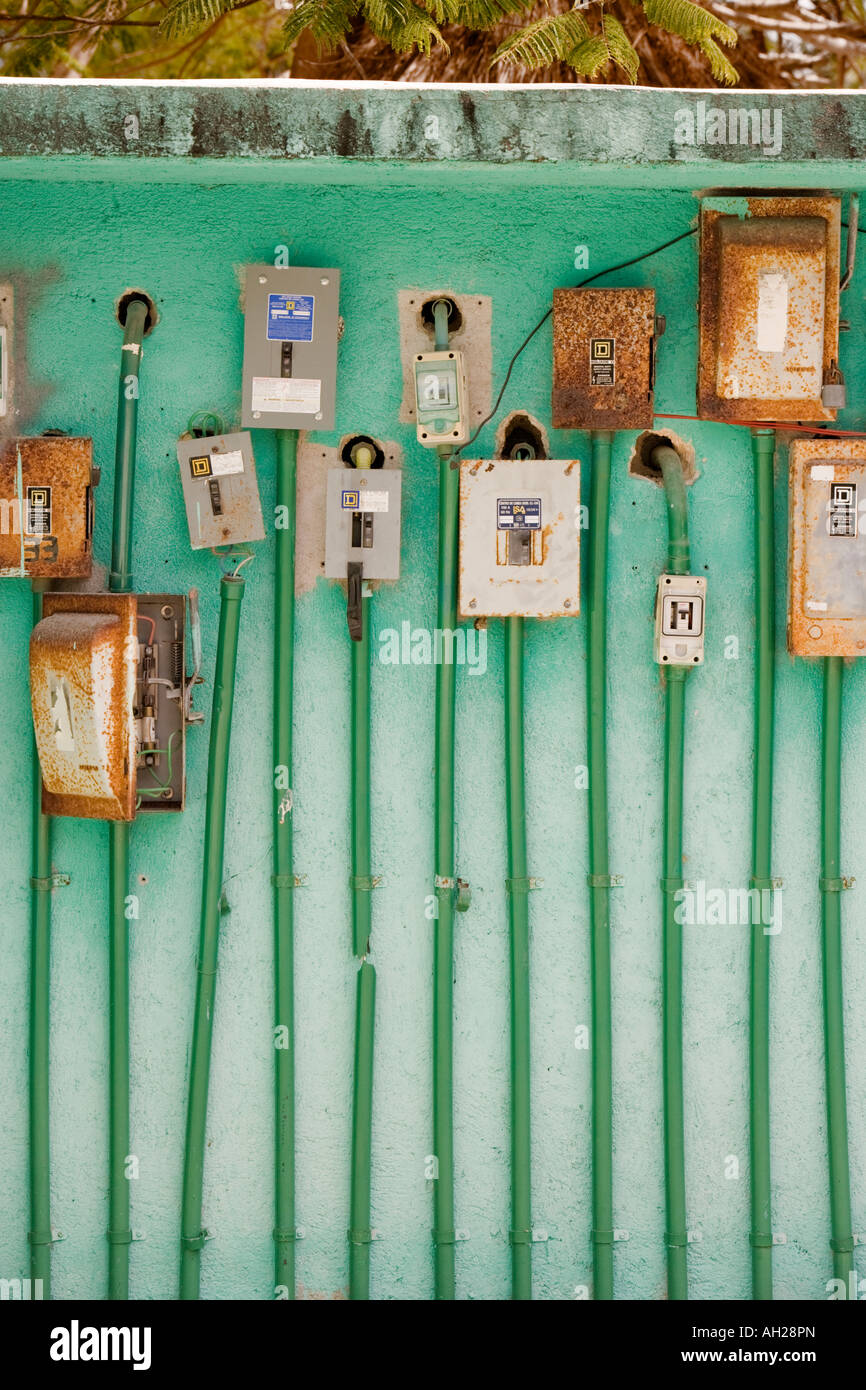 Many rusted electric panels on a green wall Stock Photo - Alamy
