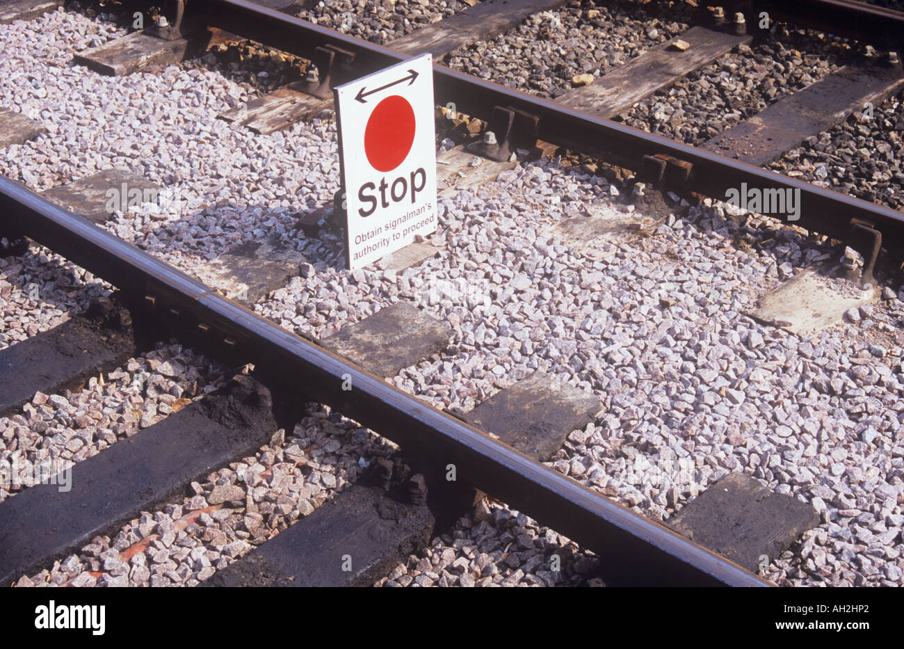 Small ground level sign in railway siding telling train drivers to Stop ...