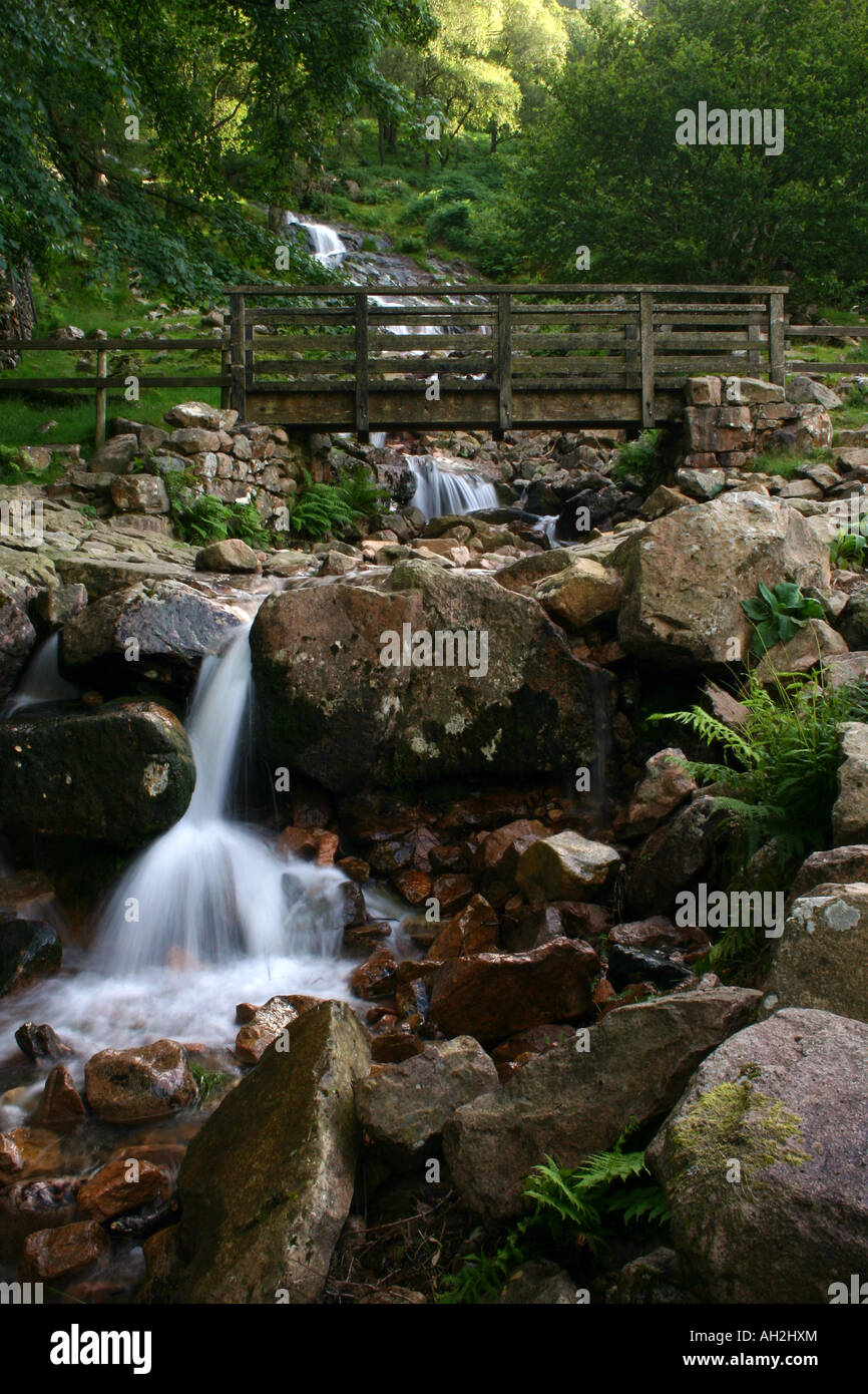 Bridge spanning waterfall into Buttermere lake showing movement in ...