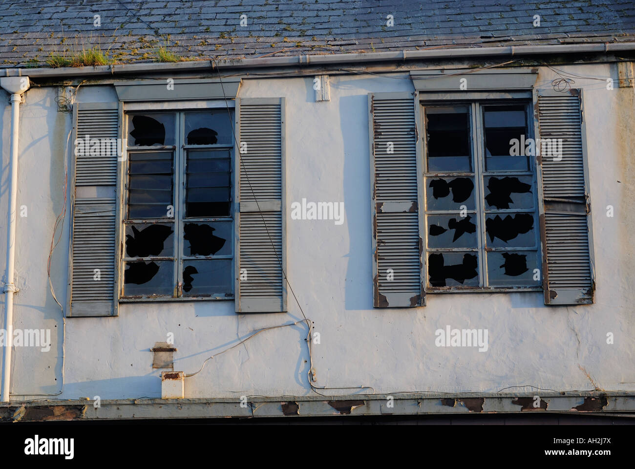 Broken windows in semi derelict building suffering from urban decay in ...