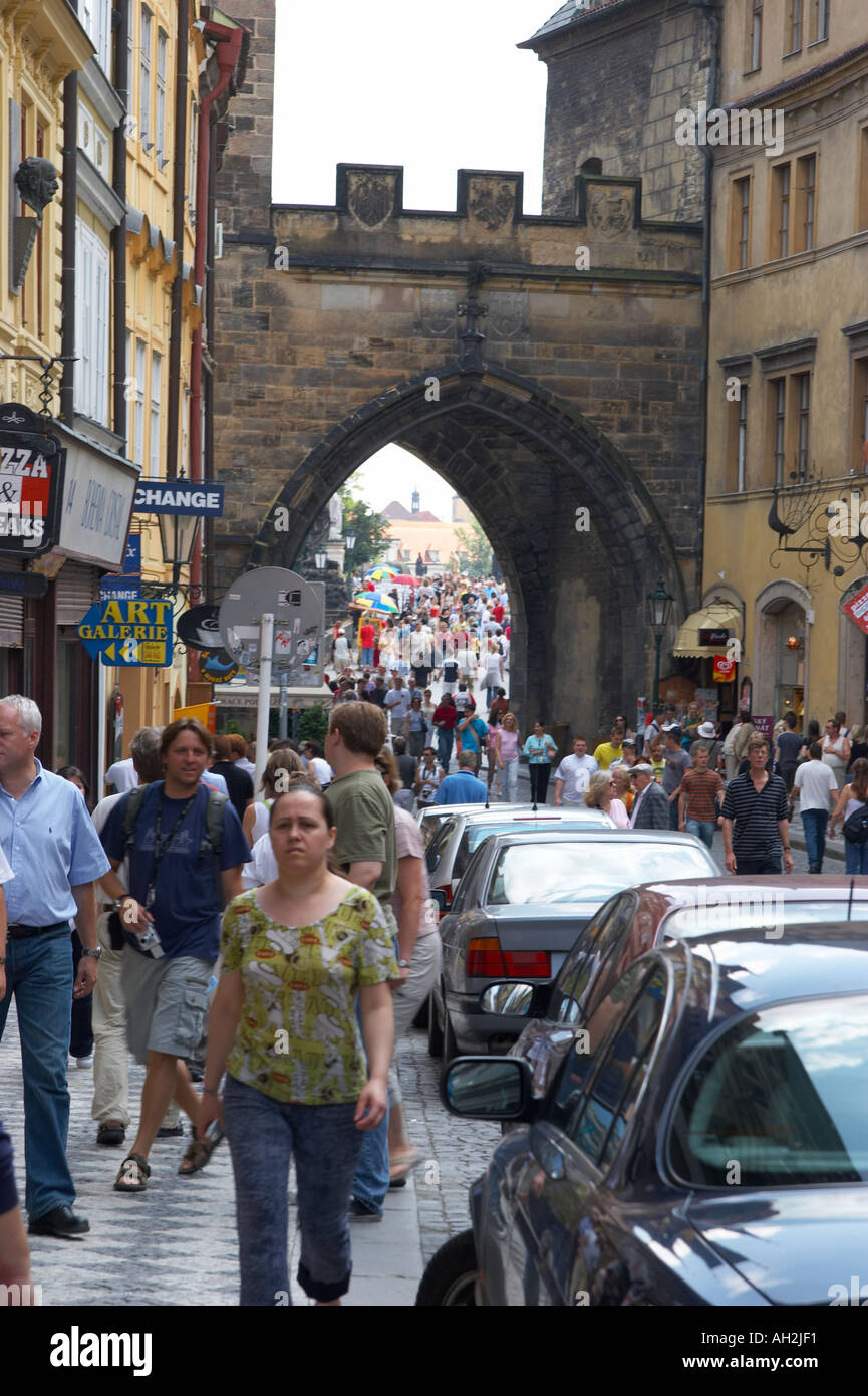 Crowd of tourists pour in from Charles IV Bridge Prague Czech Republic ...