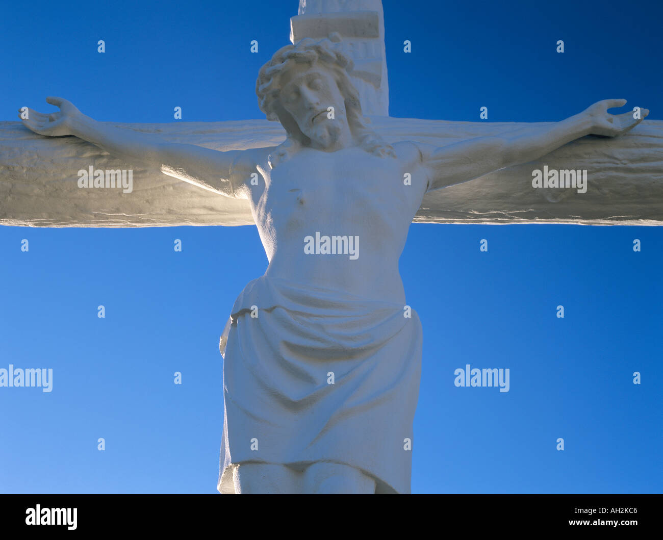 Jesus on a cross statue Stock Photo - Alamy