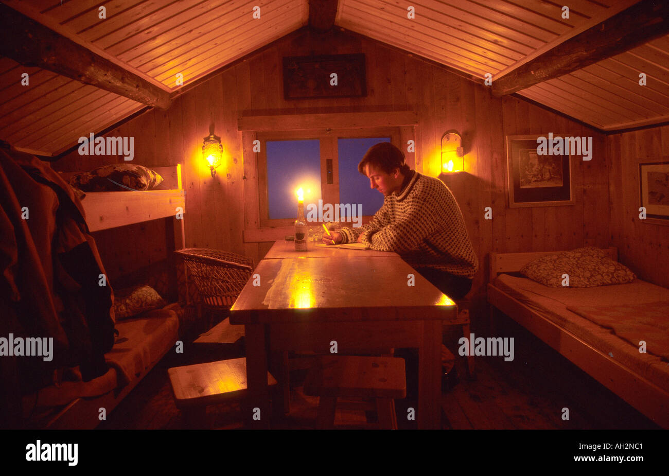 Man sitting inside cabin Stock Photo - Alamy