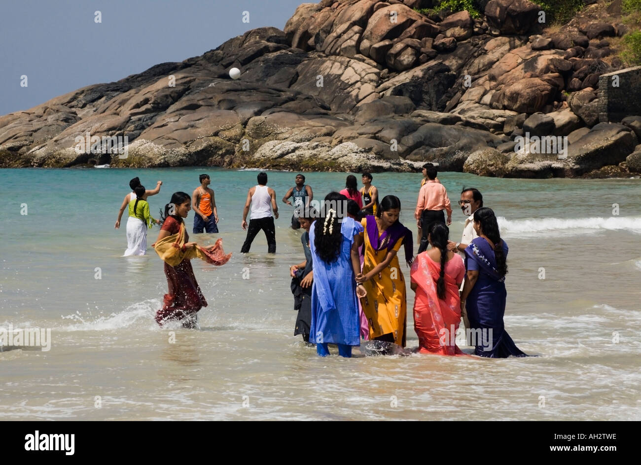 Fully clothed Indians bathing at Kovalam beach in Kerala, India Stock ...