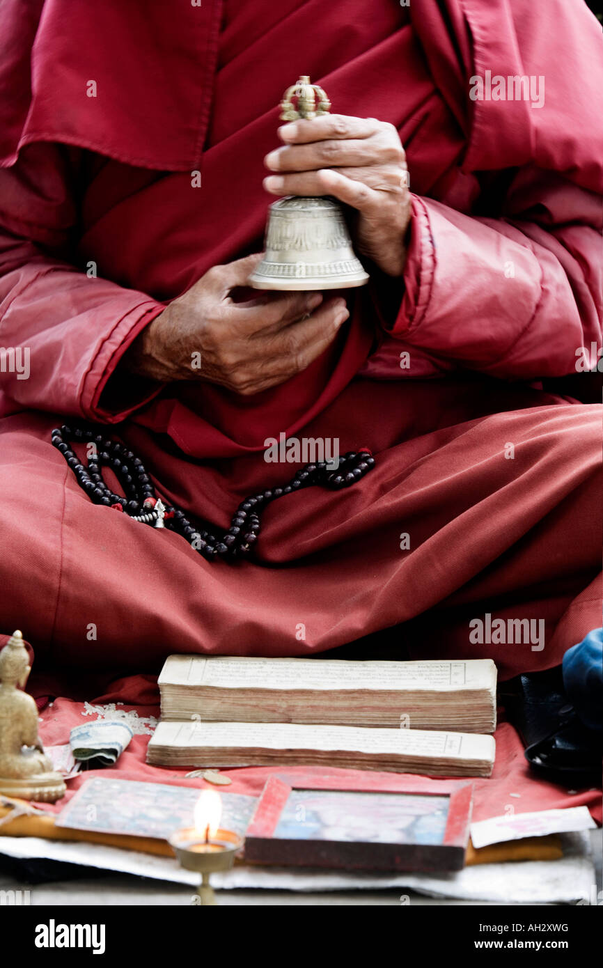 Tibetan buddhist monk ringing bell chanting on street outside Swayambhu ...