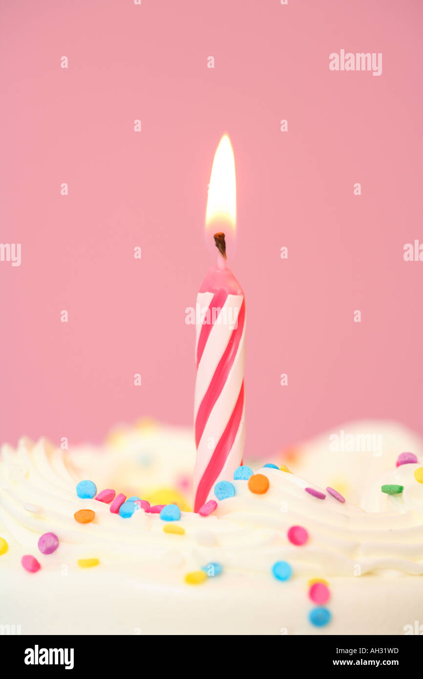 Single Birthday Candle with Pink Background Stock Photo - Alamy