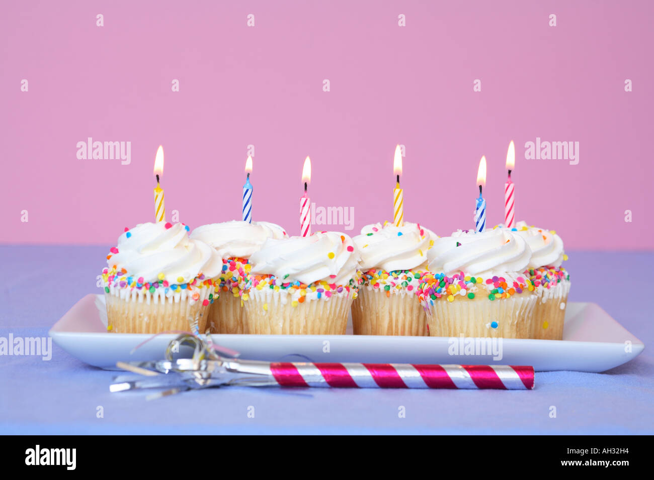 Birthday Cupcakes with Candles Stock Photo - Alamy