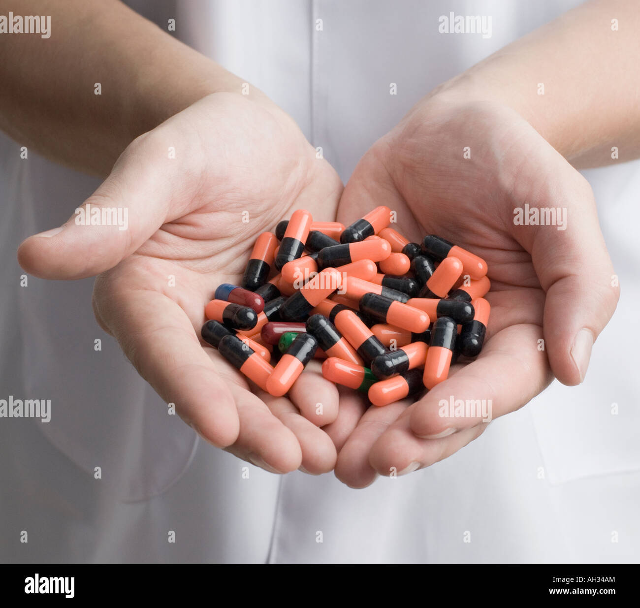 Mid section view of a man holding handful of capsules Stock Photo - Alamy