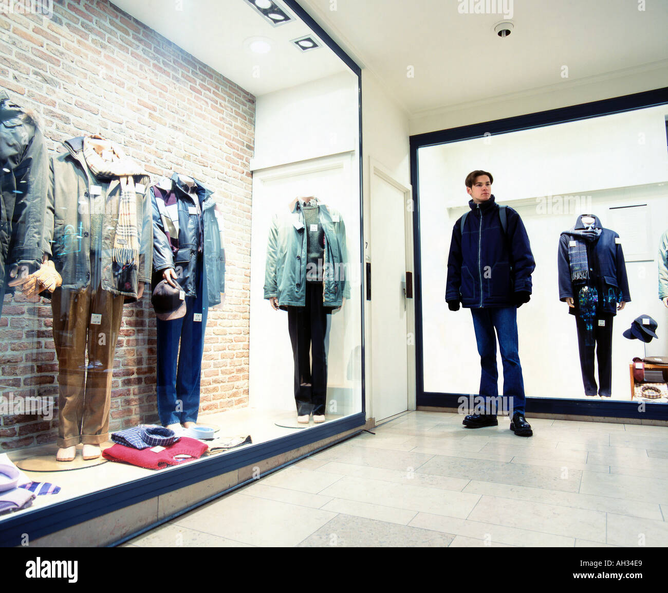 Young man at the entrance to a clothes shop Stock Photo - Alamy