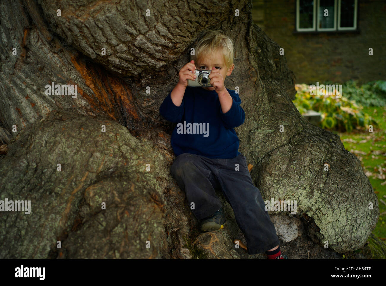 Young boy with a camera Stock Photo - Alamy