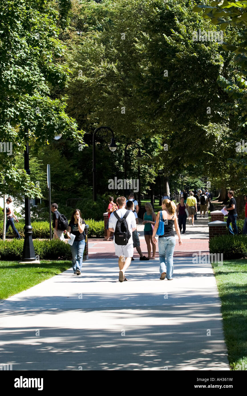 Students walking on a walkway along Old Main on the campus of the ...