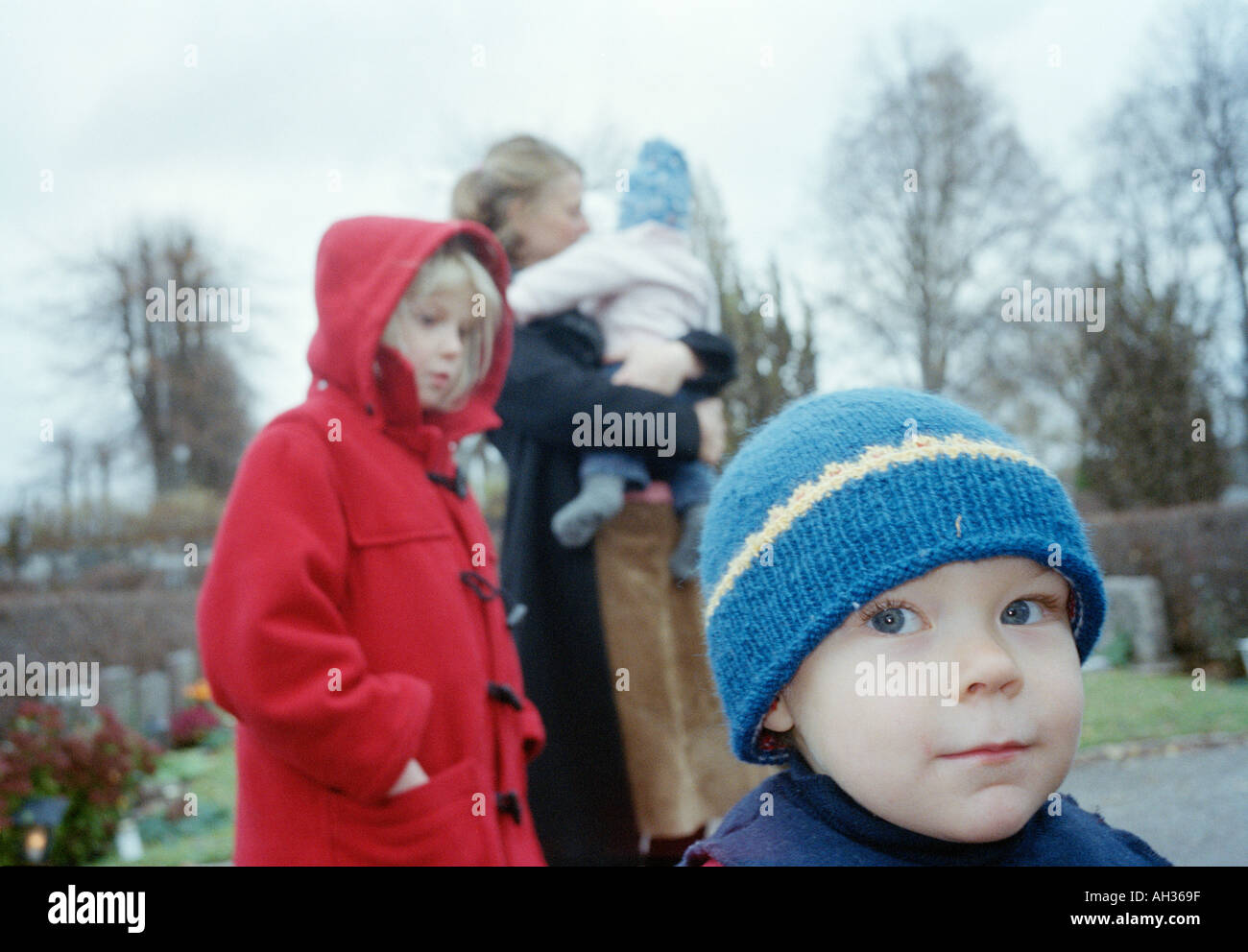 Little boy and his family visting a cemetery Stock Photo - Alamy