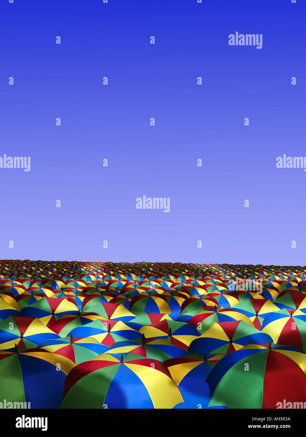 vast sea of umbrellas against blue summer sky with one flying away rain ...