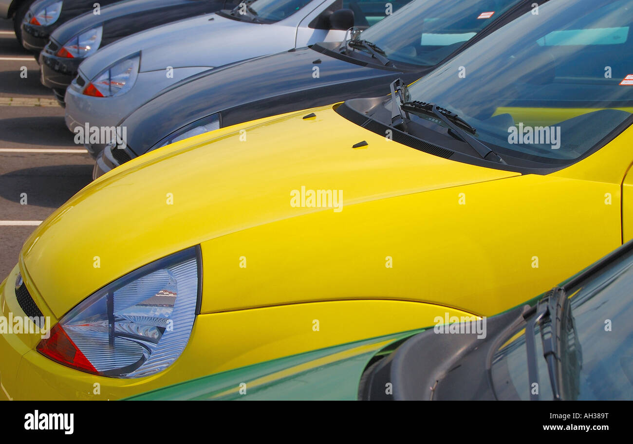striking yellow Ford Ka in parking lot among many grey cars Stock Photo ...