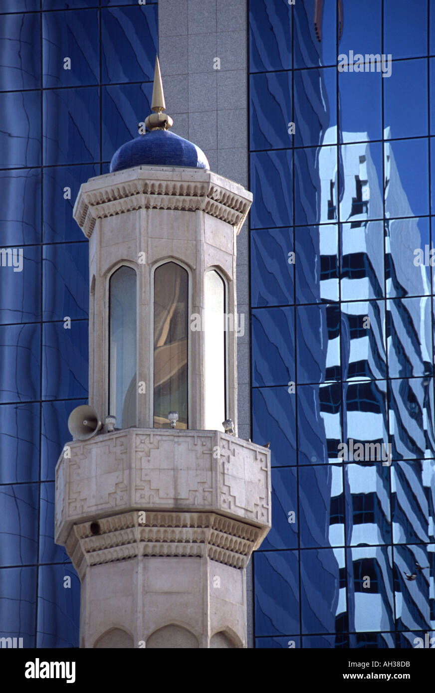 Minarate of a mosque and modern skyline Stock Photo - Alamy