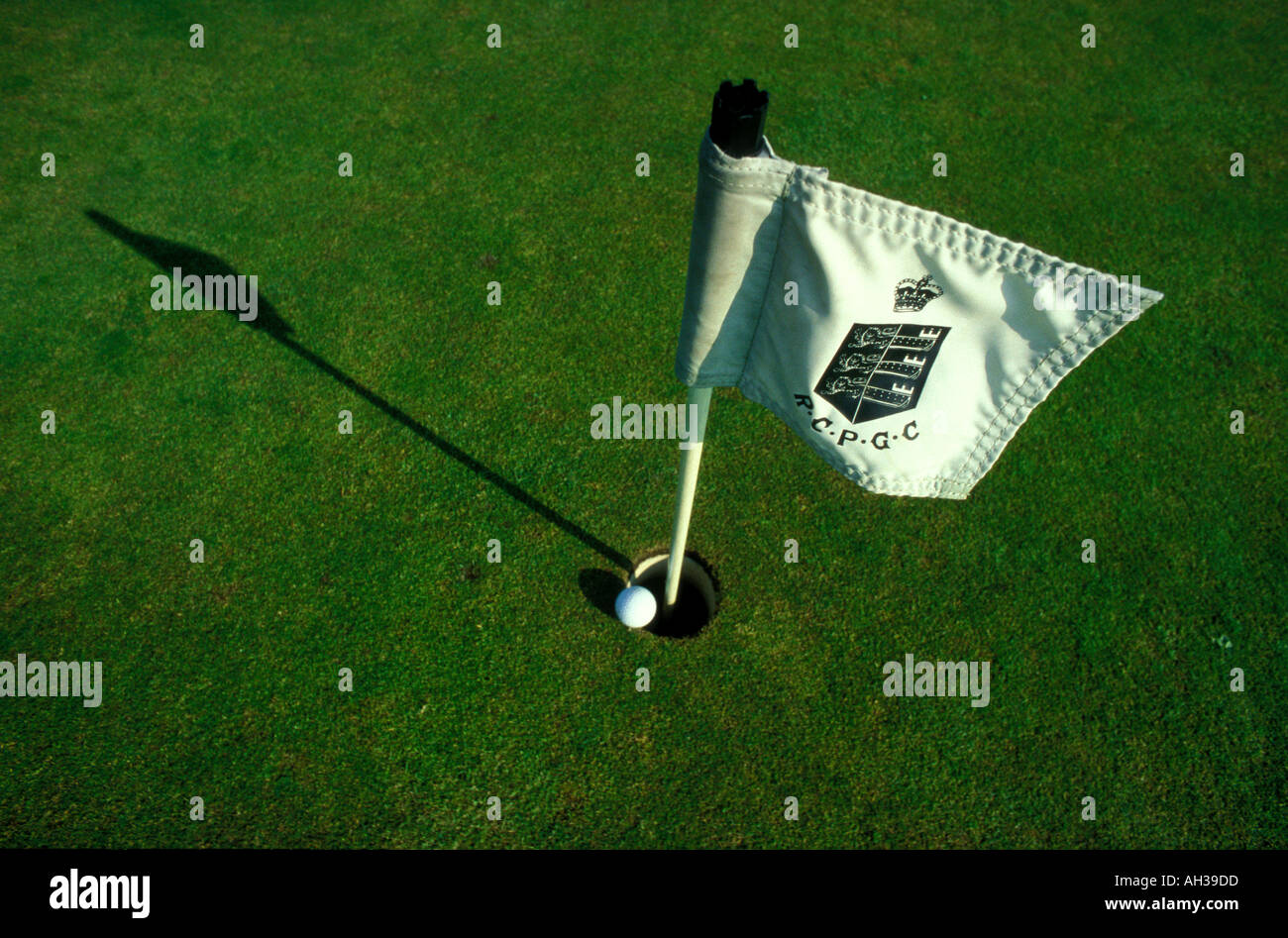 golf pin on putting green with ball Stock Photo - Alamy