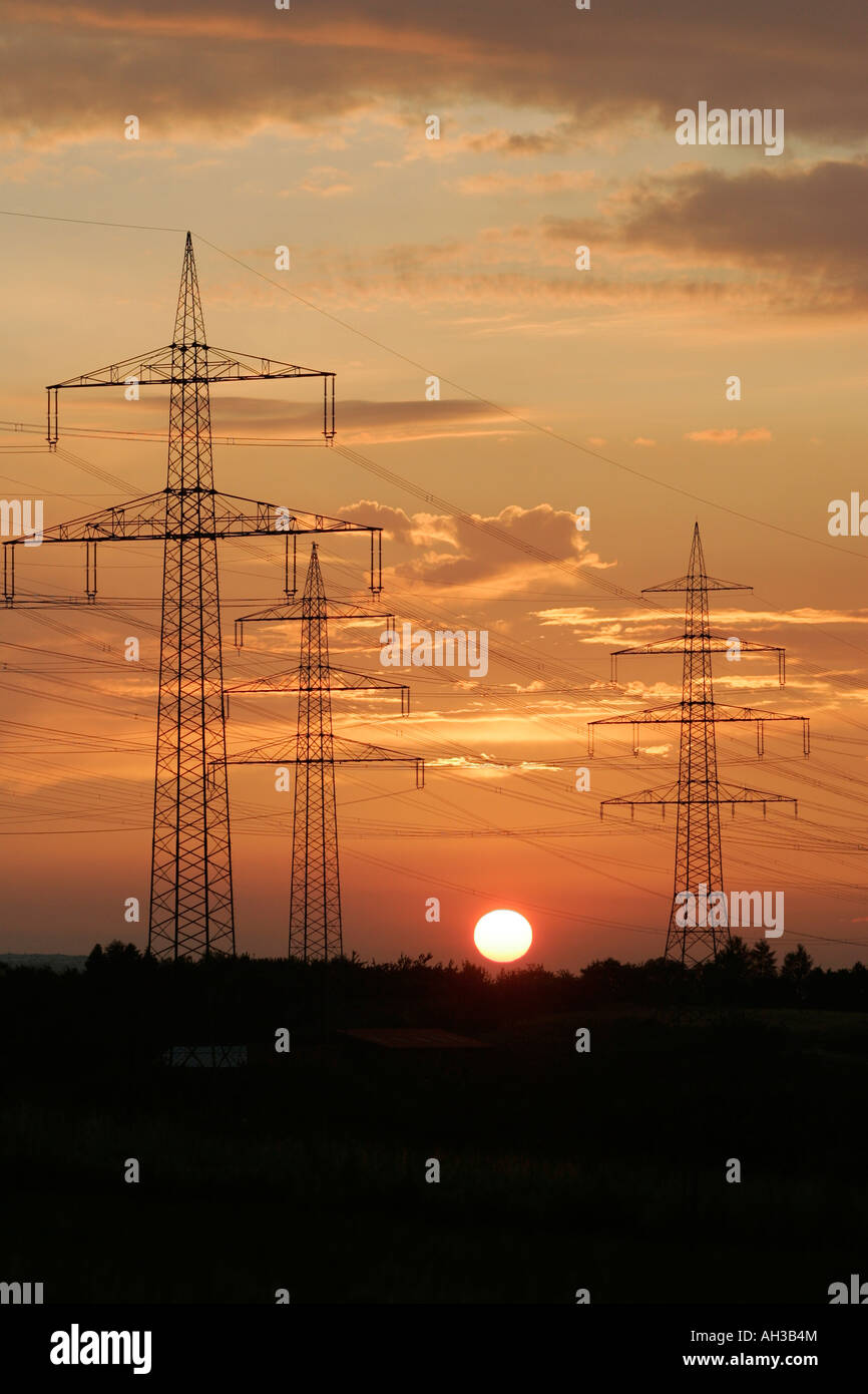 Electric power lines at sunset Stock Photo - Alamy