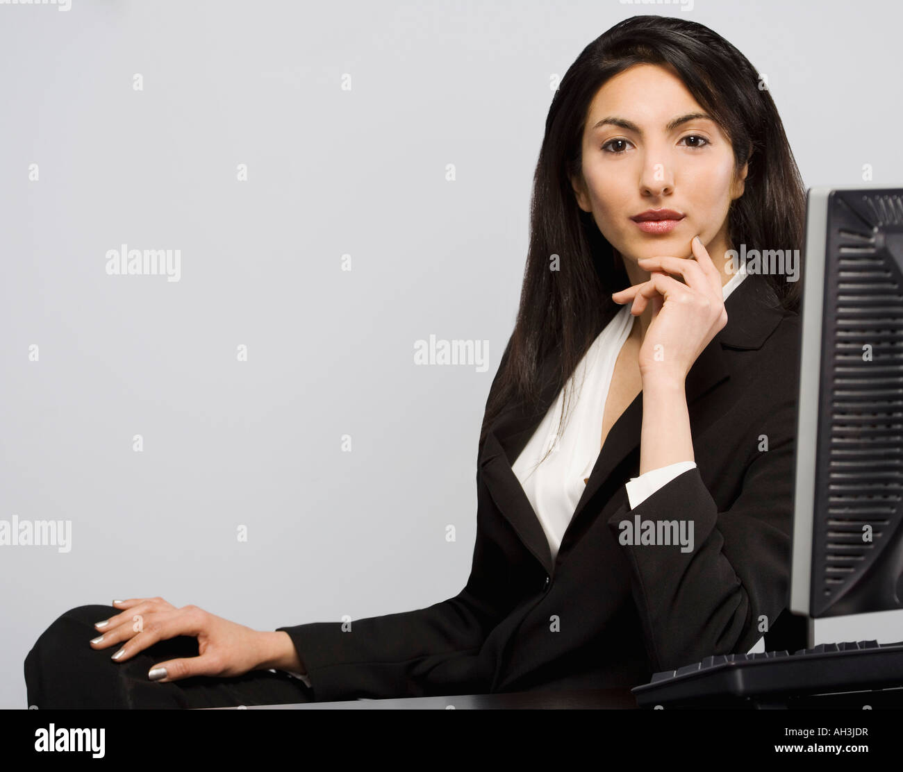 Woman sitting at computer Stock Photo - Alamy