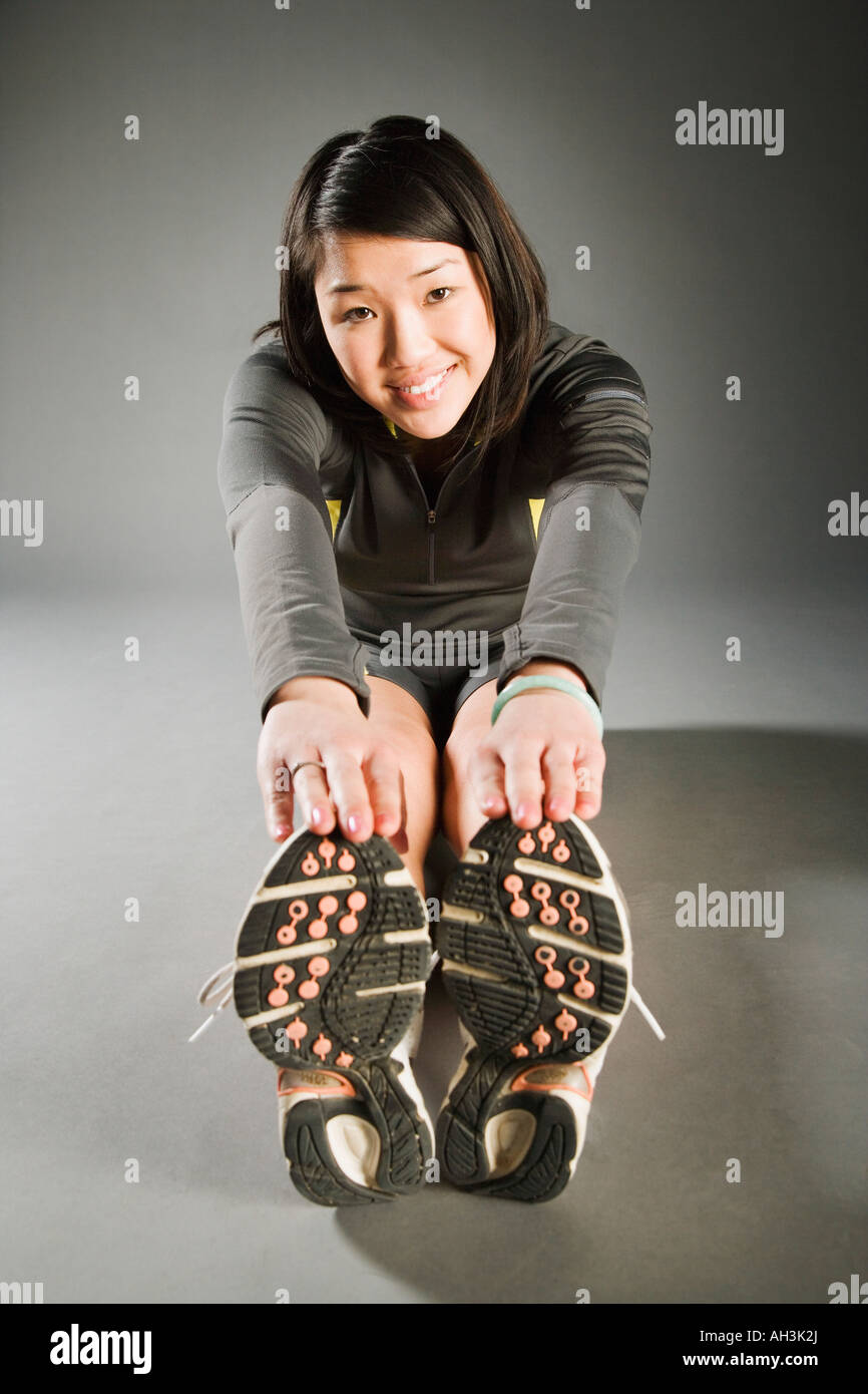 Athlete stretching leg muscles Stock Photo - Alamy
