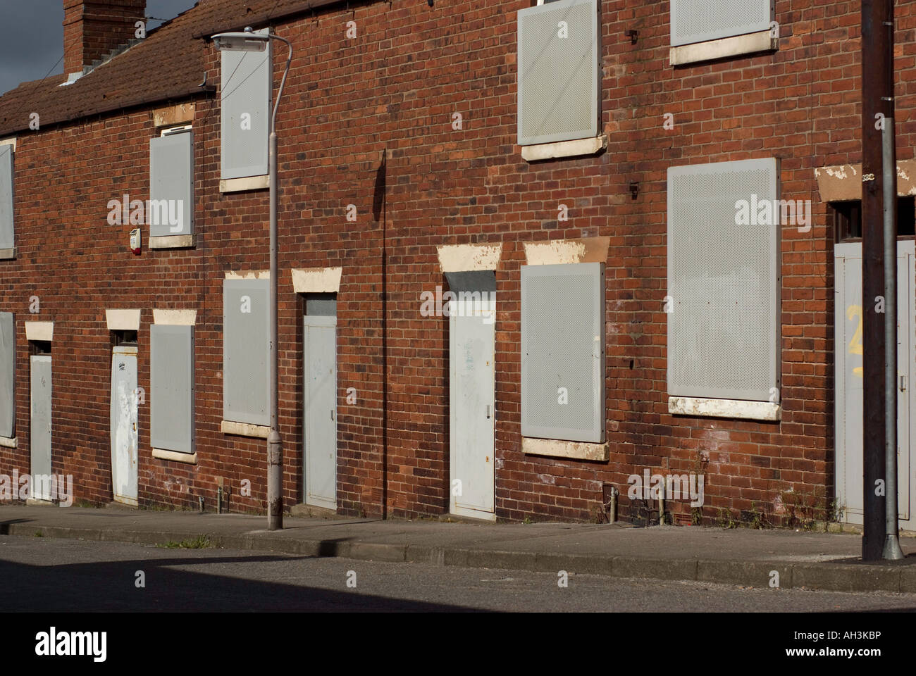 Depressed area with terraced houses boarded up Stock Photo - Alamy