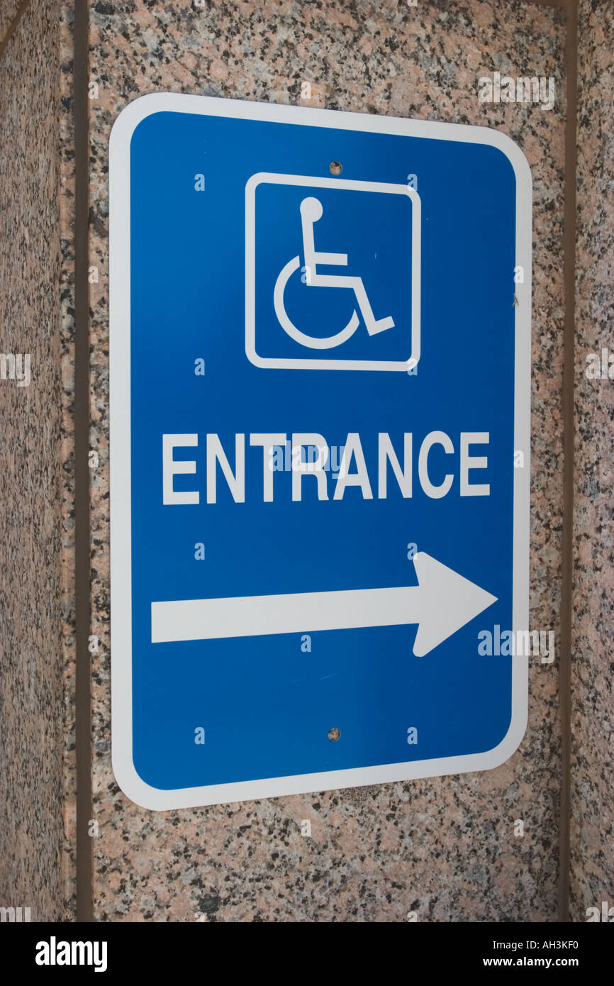 Blue handicapped entrance sign with a white arrow on it Stock Photo - Alamy