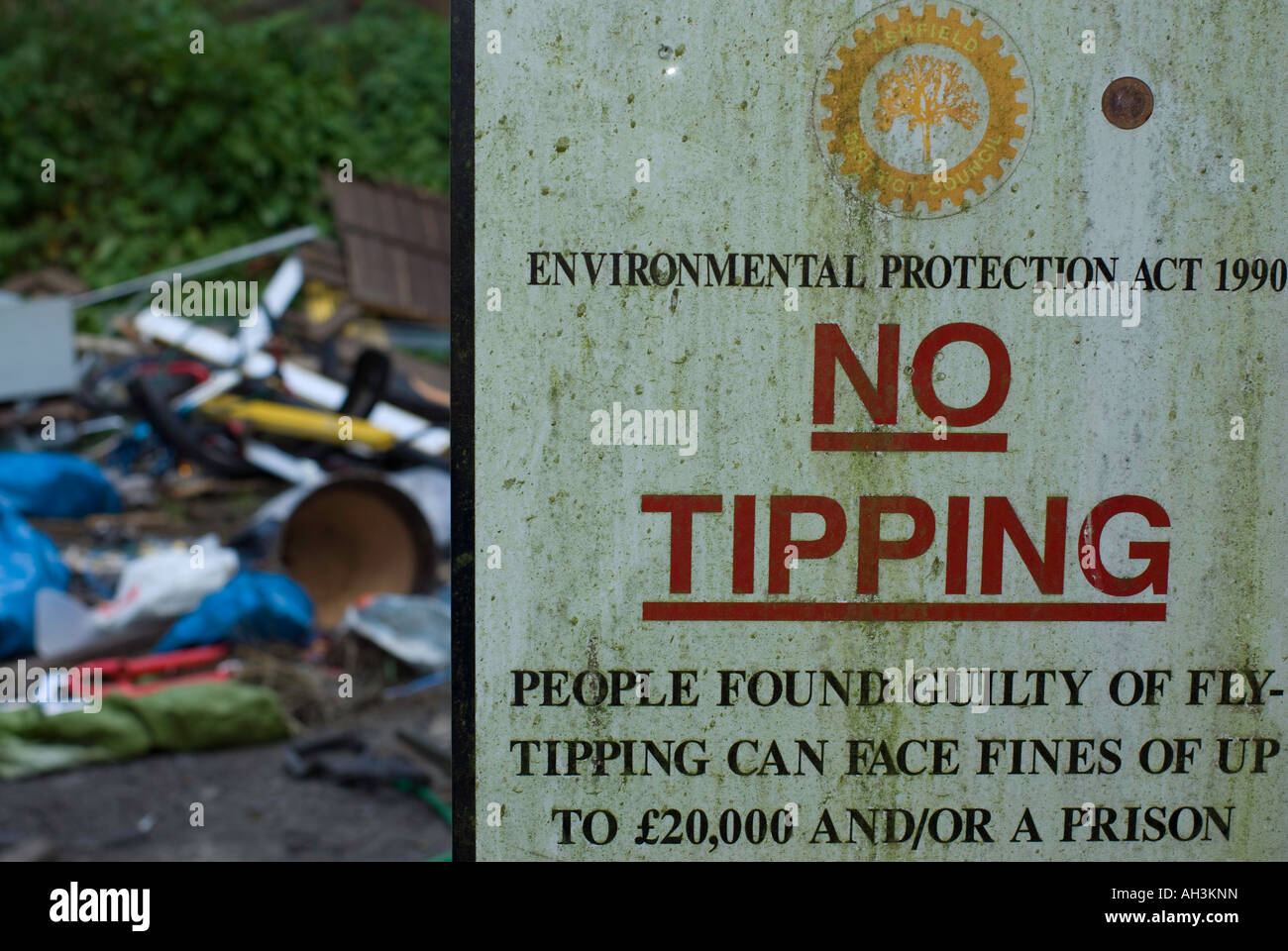 Sign with "No tipping" behind which is rubbish Stock Photo - Alamy