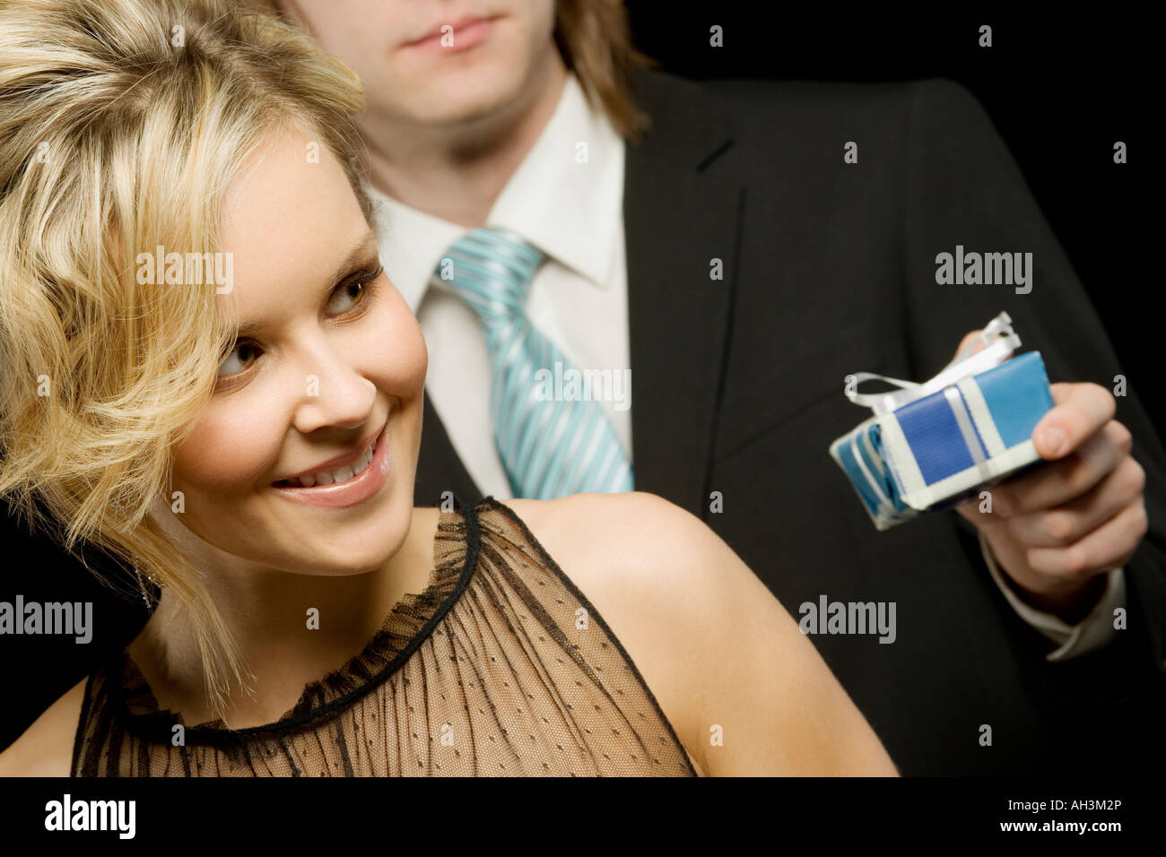 Man offering a gift to woman Stock Photo - Alamy